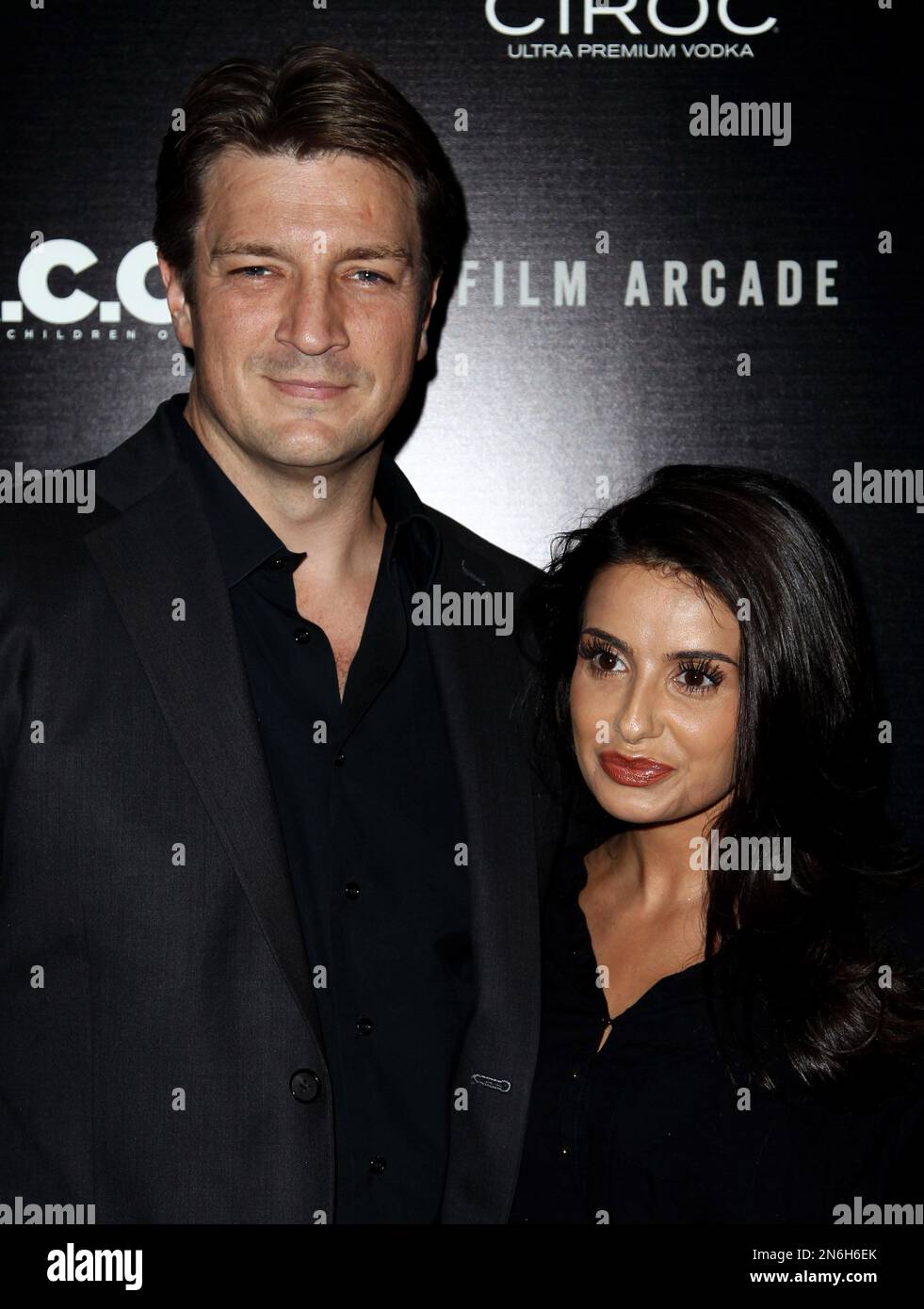 Nathan Fillion, left, and Mikaela Hoover arrive at the premiere of "A.C ...