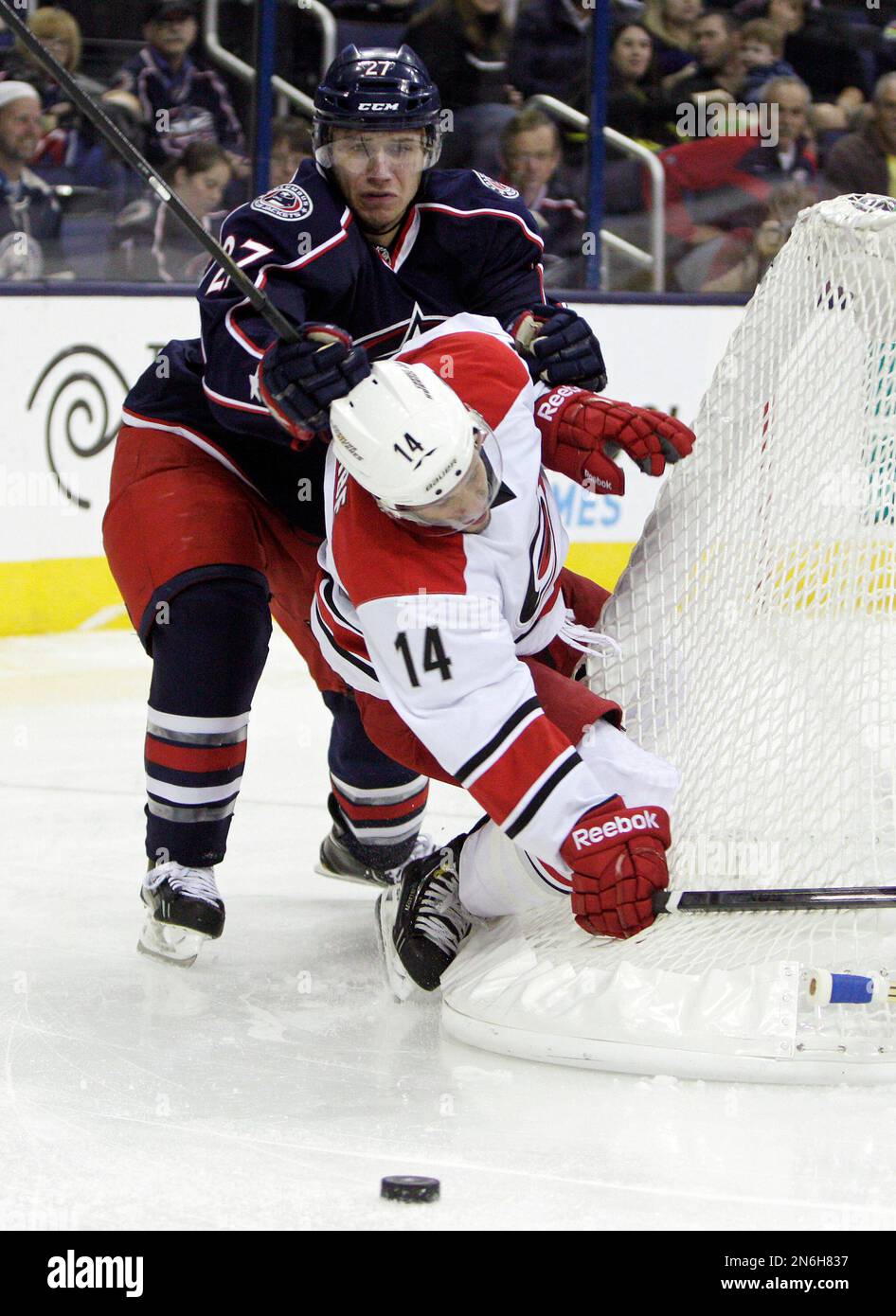 Columbus Blue Jackets' Ryan Murray, left, checks Carolina Hurricanes ...