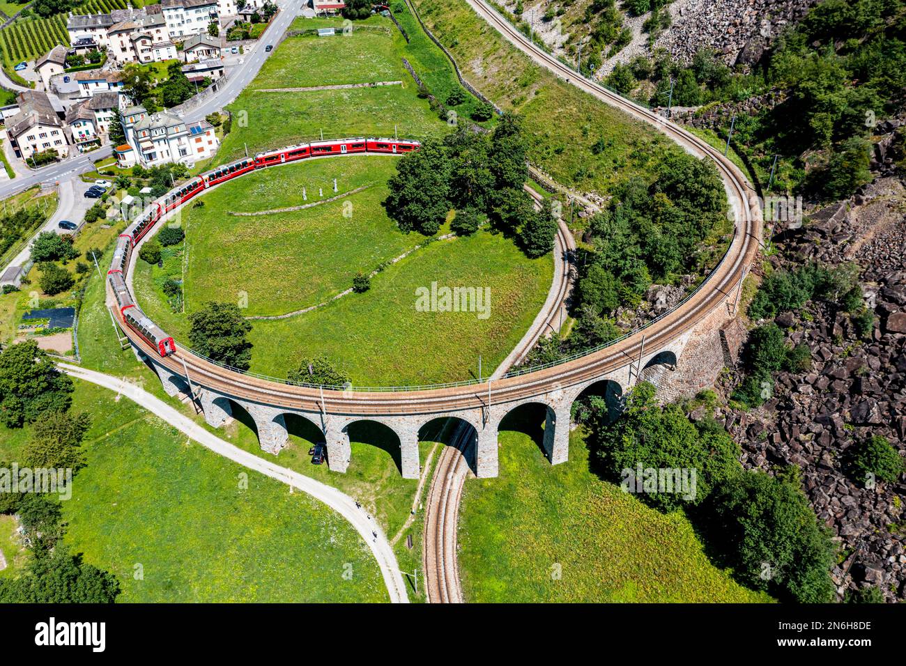 Aerial of a Train crossing the Brusio spiral viaduct, Unesco world ...