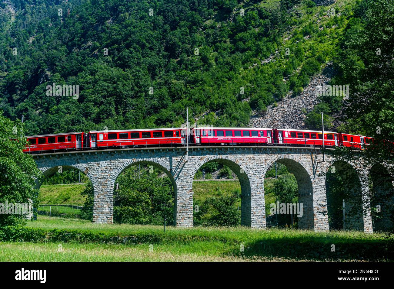 Train crossing the Brusio spiral viaduct, Unesco world heritage site ...