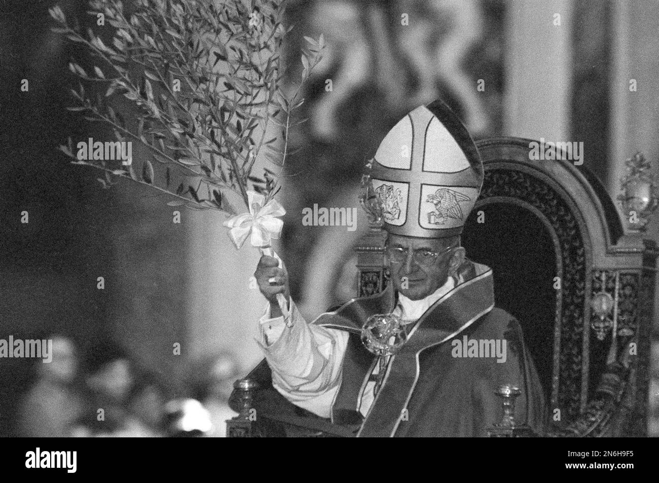 Pope Paul VI holding olive branch while being carried on portable ...
