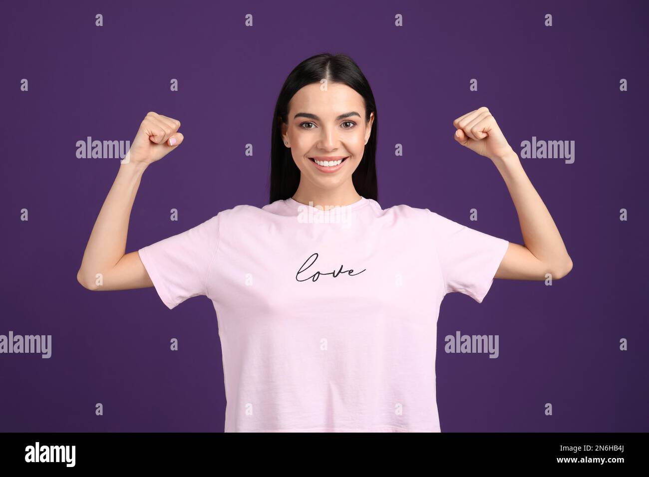 Strong woman as symbol of girl power on purple background. 8 March ...