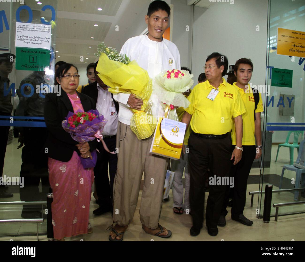 Myanmar's tallest man Win Zaw Oo, second from left, who is seven feet, eight inches (233 ...