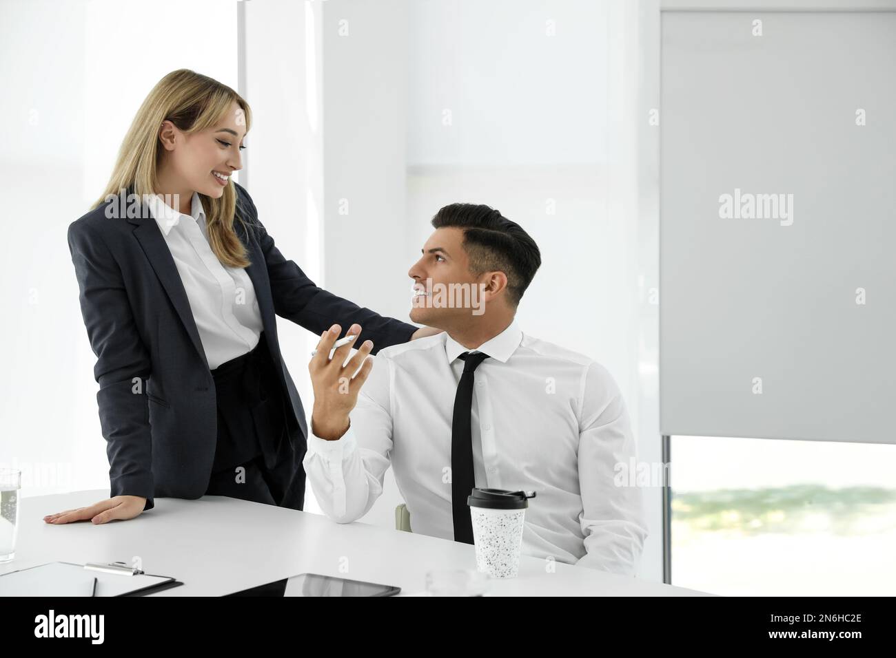 Office employees talking at workplace during break Stock Photo - Alamy