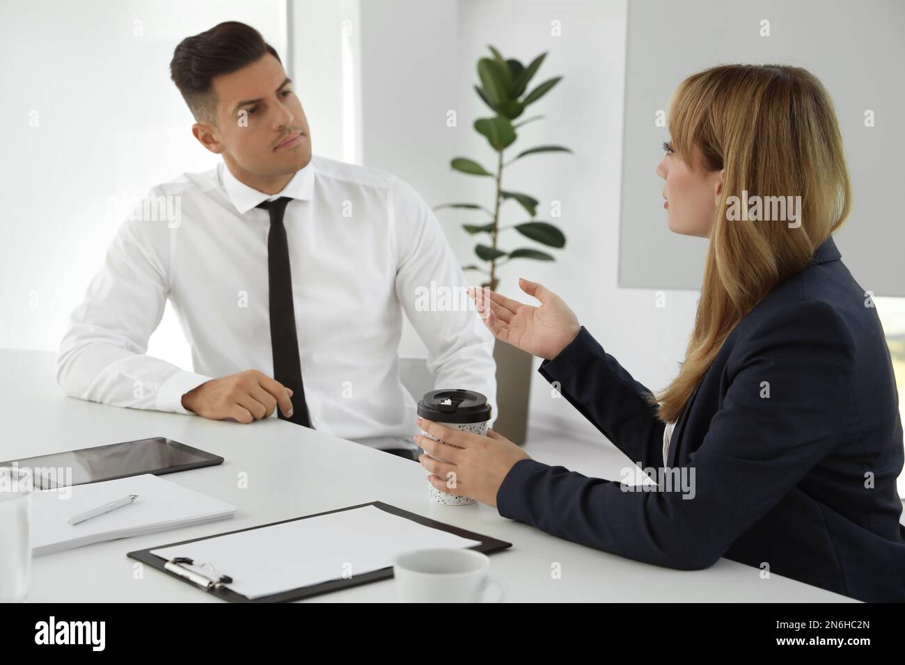 Office employees talking at table during meeting Stock Photo - Alamy