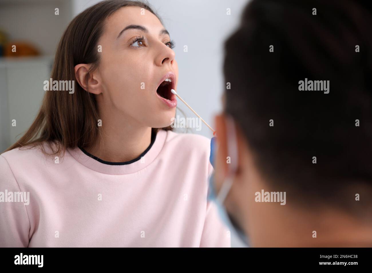 Doctor taking sample for DNA test from woman in clinic Stock Photo - Alamy