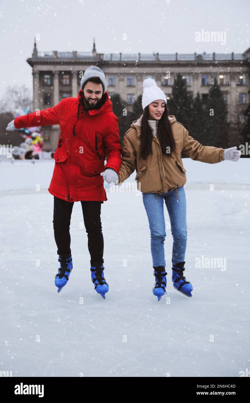 Active young couple ice skating hi-res stock photography and images - Alamy