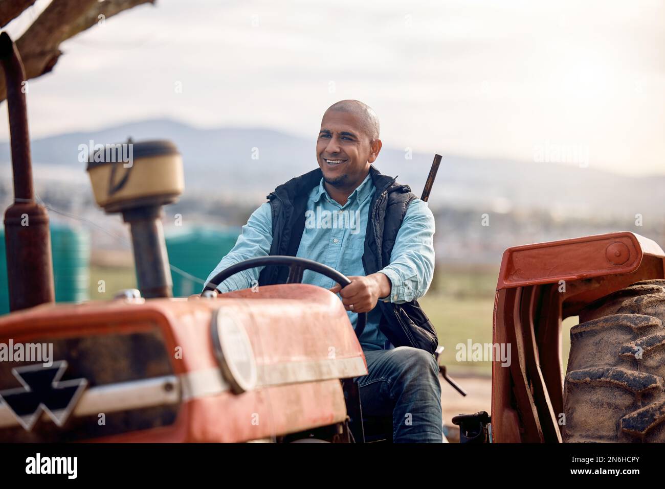 Tractor, man and driver on field for agriculture, countryside or ...