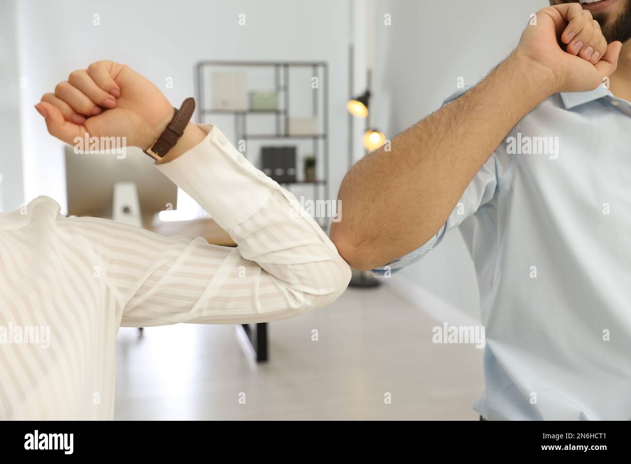 People greeting each other by bumping elbows instead of handshake in ...