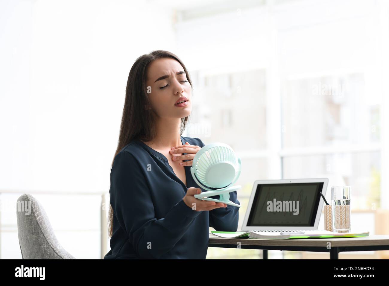 Woman holding portable fan hi-res stock photography and images - Alamy
