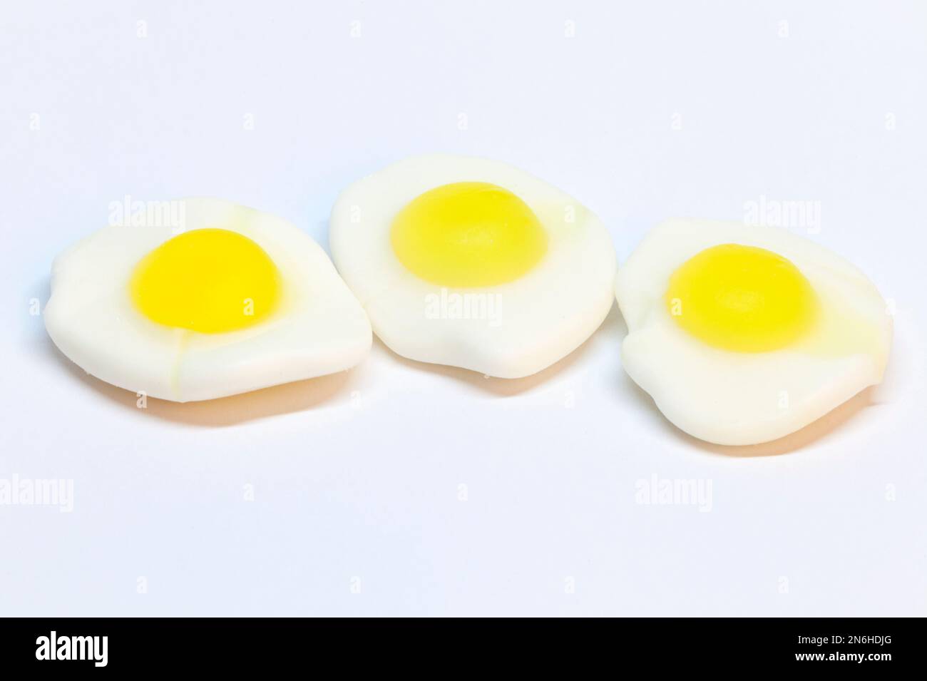 three pieces of fried candy eggs on a white background Stock Photo - Alamy
