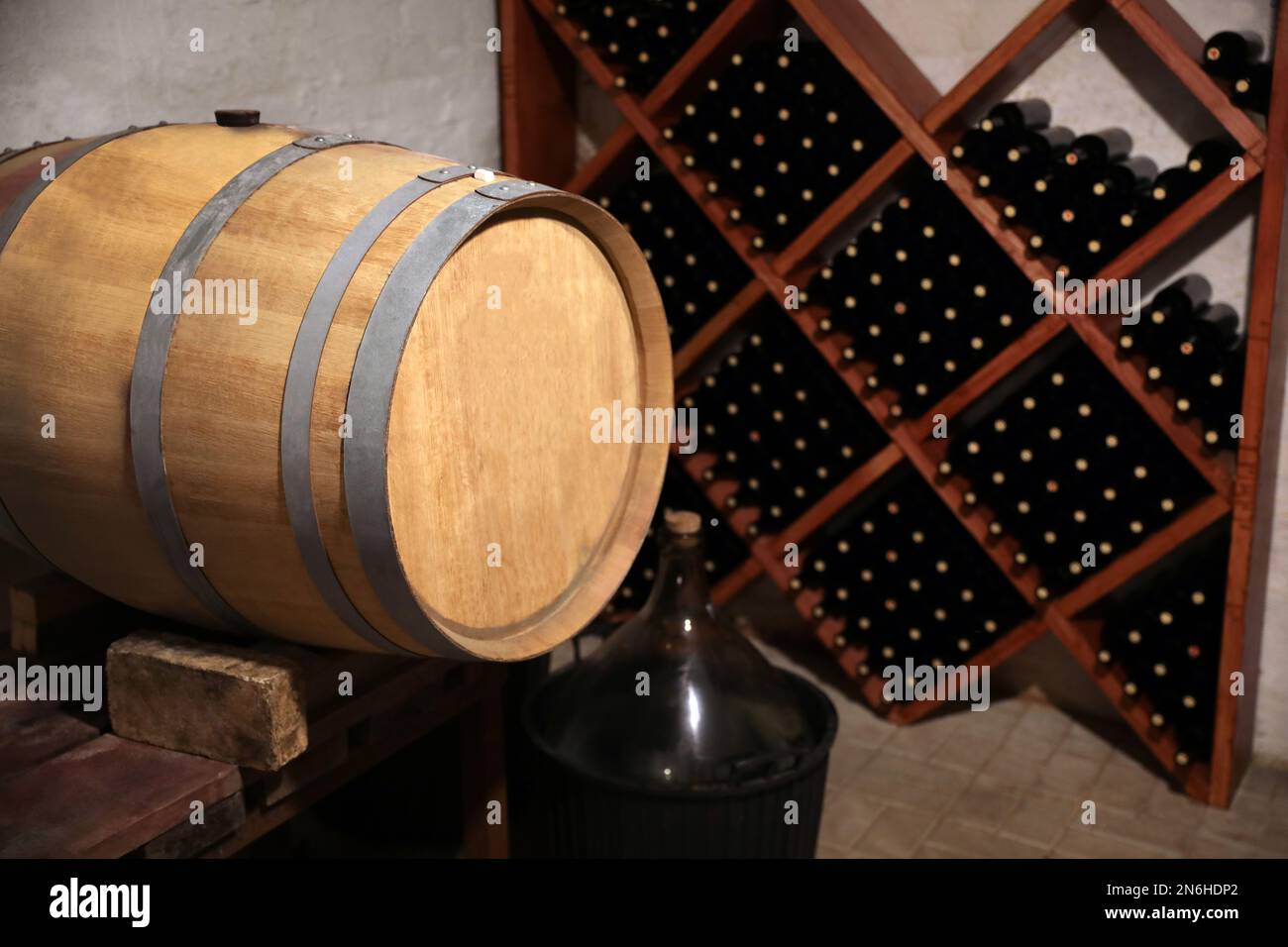 Large wooden barrel on table in wine cellar Stock Photo - Alamy