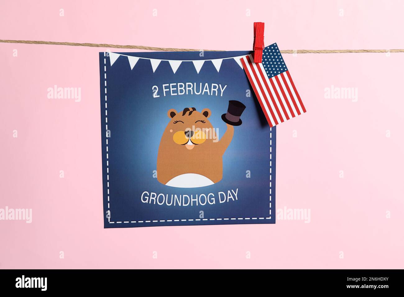 Happy Groundhog Day greeting card and American flag hanging on pink ...