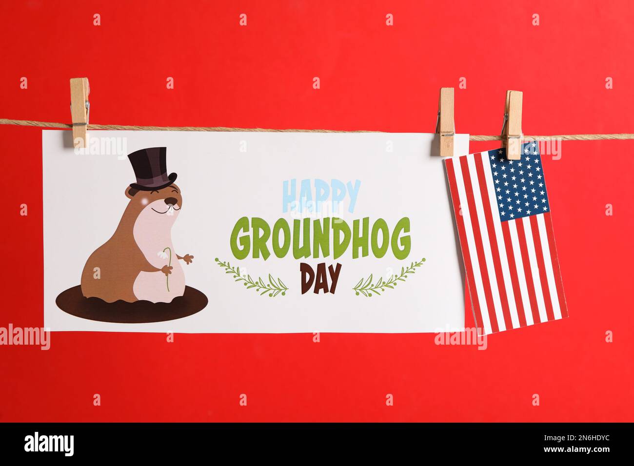 Happy Groundhog Day greeting card and American flag hanging on red ...