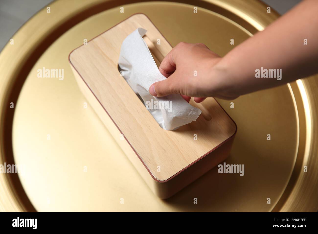 Woman taking paper tissue out of box on table, above view Stock Photo ...