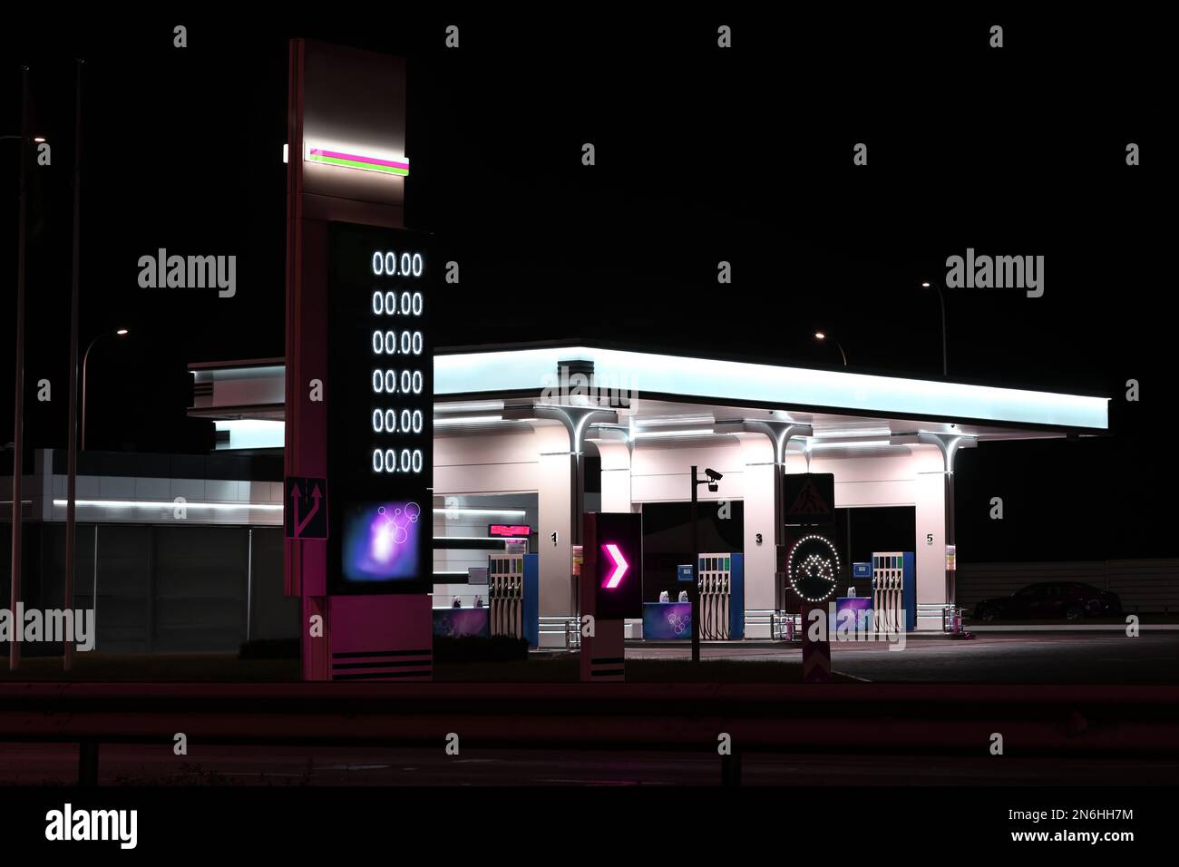 Modern gas station with convenience store beside the road at night ...