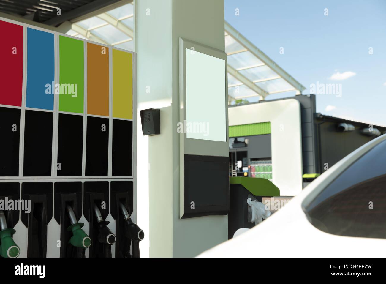 Fuel pistols and advertising board at modern gas filling station Stock ...