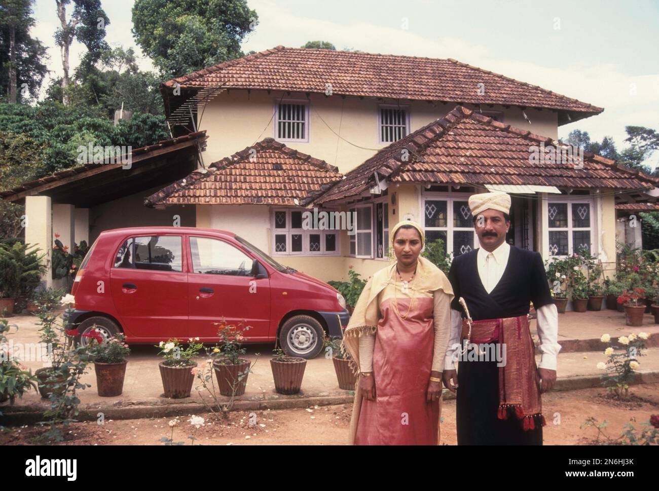 Kodava couple in traditional house in front of their house, Kodagu ...