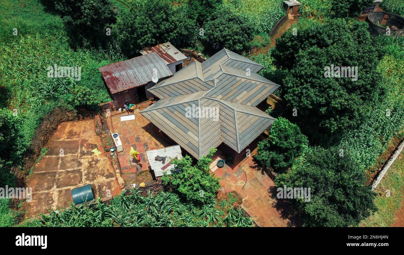 An aerial view of a house surrounded by trees and vegetation Stock ...