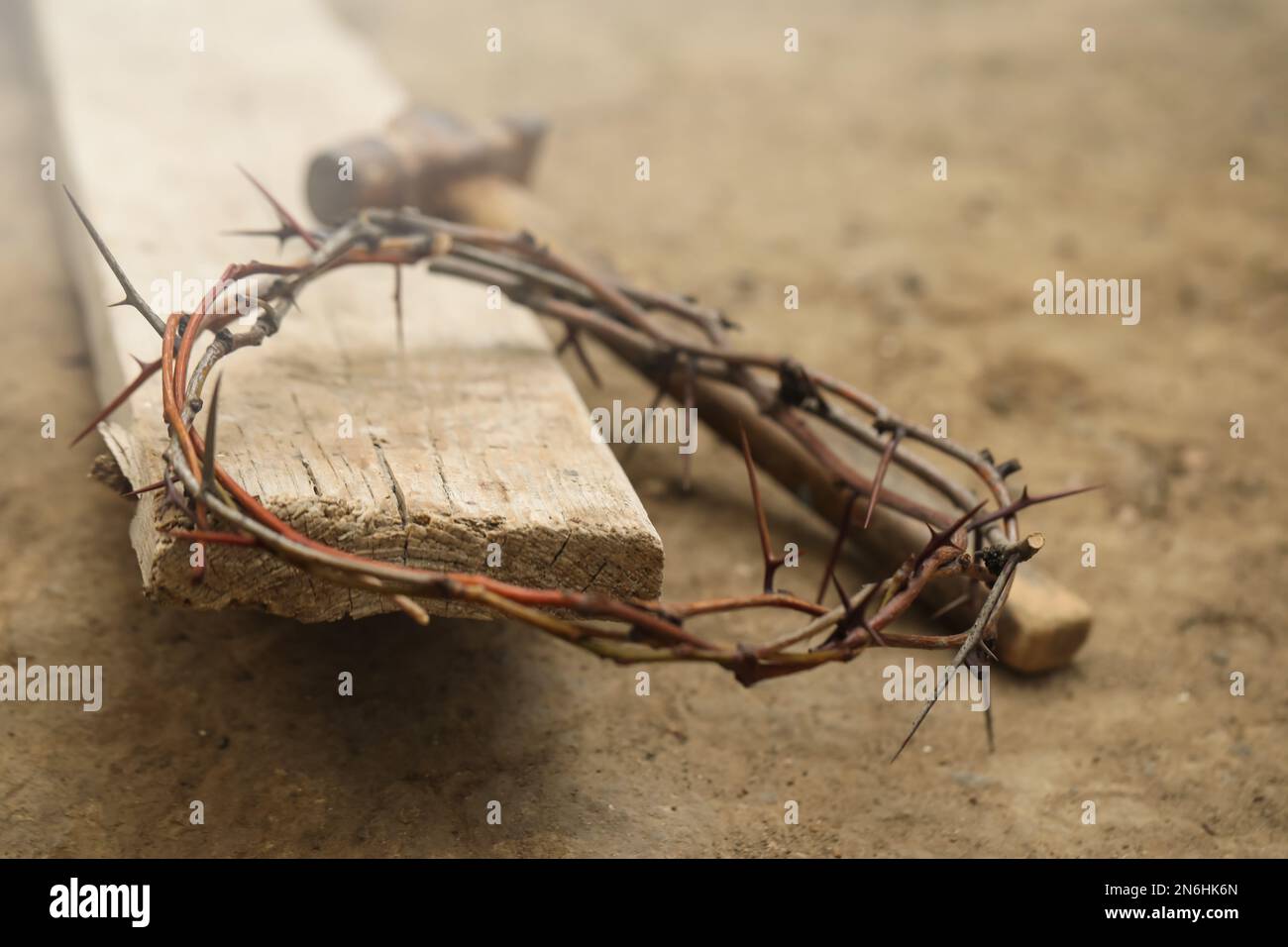 Crown of thorns, hammer and wooden plank on ground. Easter attributes ...