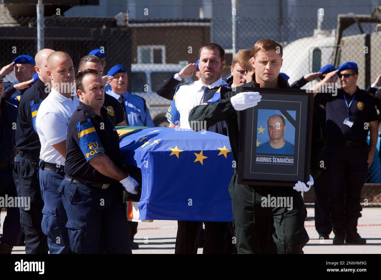 EULEX members carry the coffin draped with Lithuanian and EU flag ...