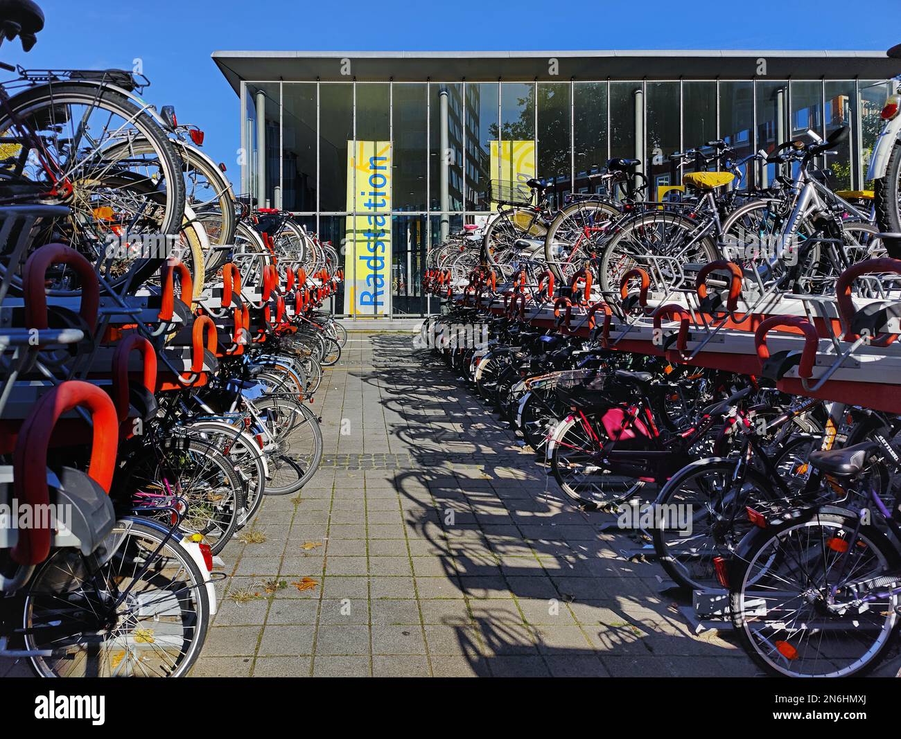 Very many bicycles at the parking spaces of the bike station at the ...