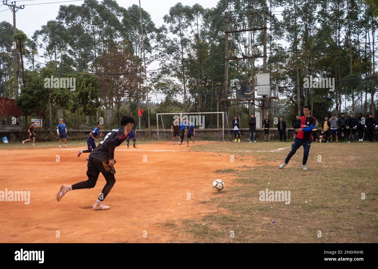 A player lines up to kick the ball in a local football match near the ...