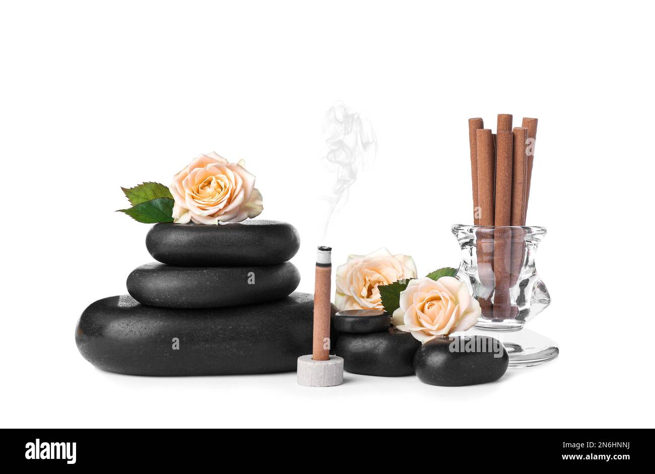 Composition with smoldering incense stick, roses and spa stones on ...