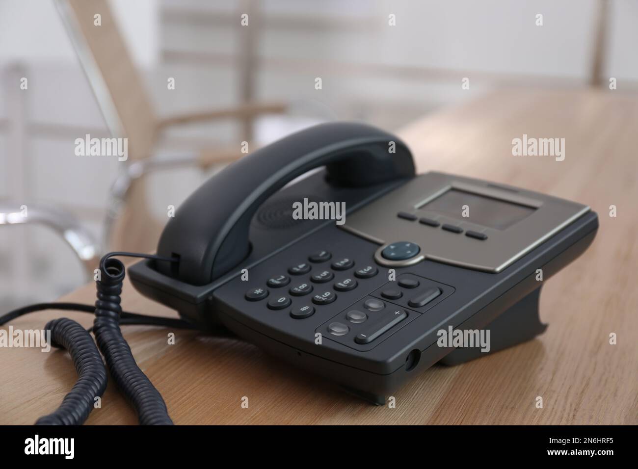 Desktop telephone on wooden table in office. Hotline service Stock ...