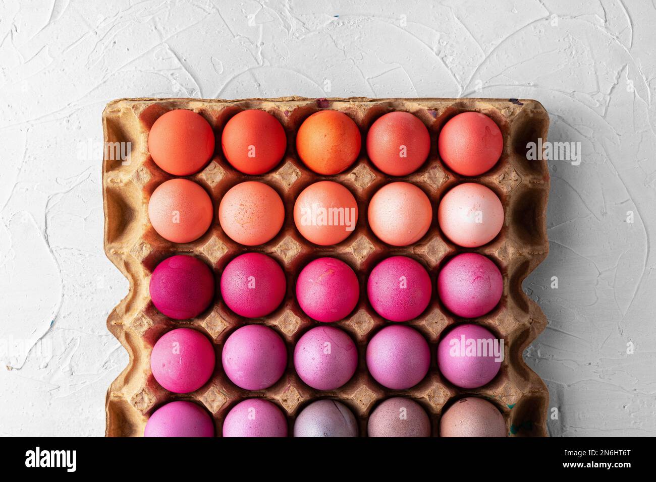Several Easter eggs in different shades of pink in eggbox Stock Photo - Alamy