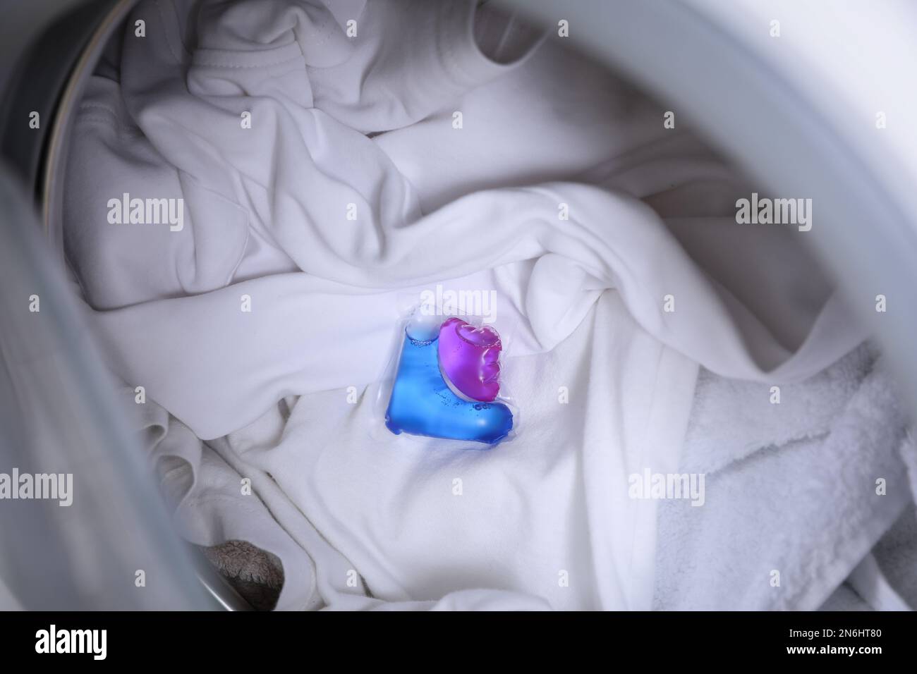 Laundry detergent capsule in washing machine drum, closeup view Stock ...