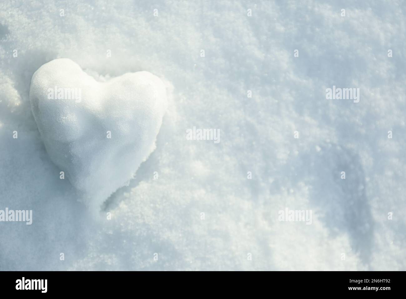 Heart shaped snowball on snow, top view. Space for text Stock Photo - Alamy
