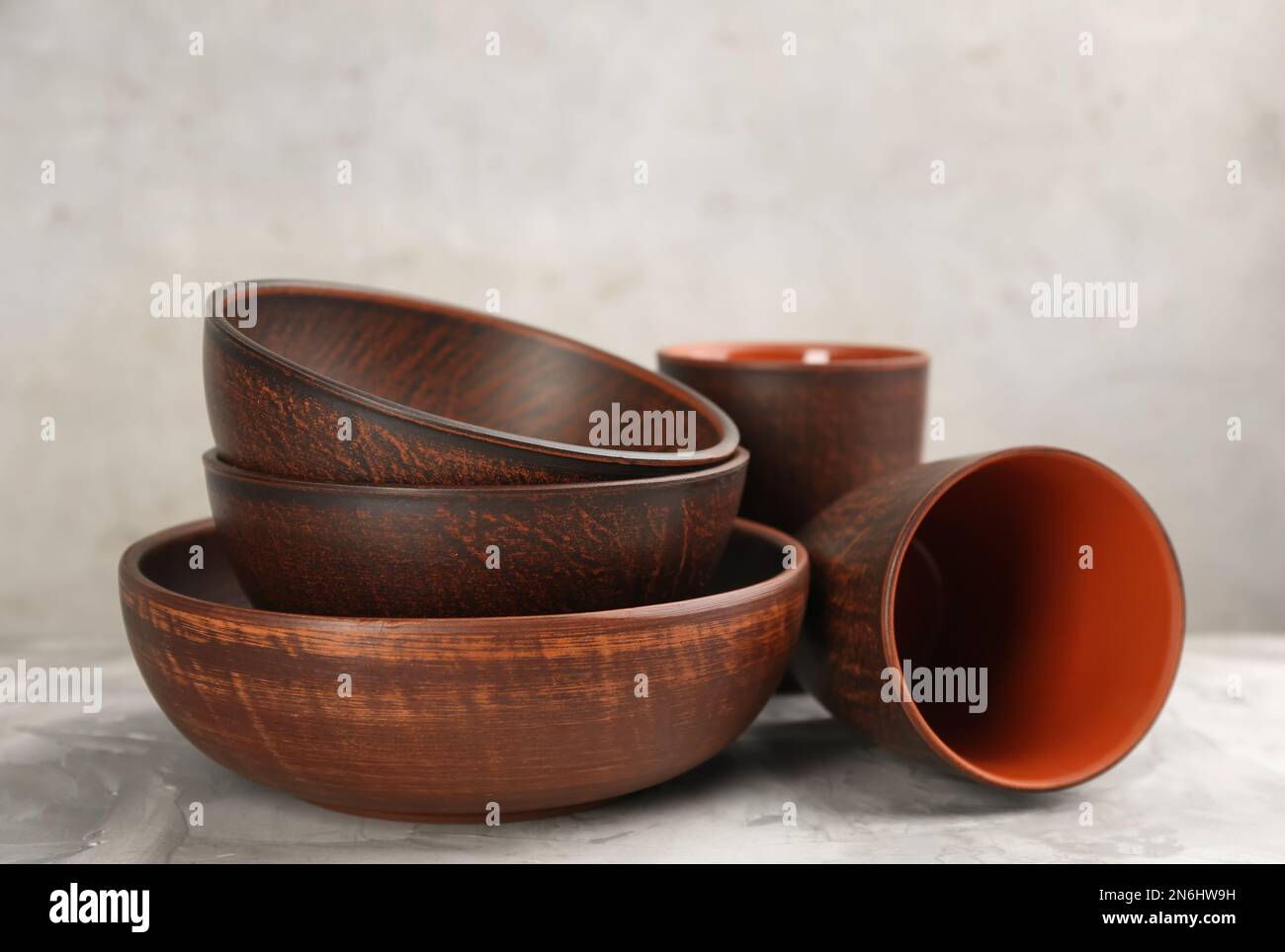 Set of clay dishes on light grey table Stock Photo - Alamy