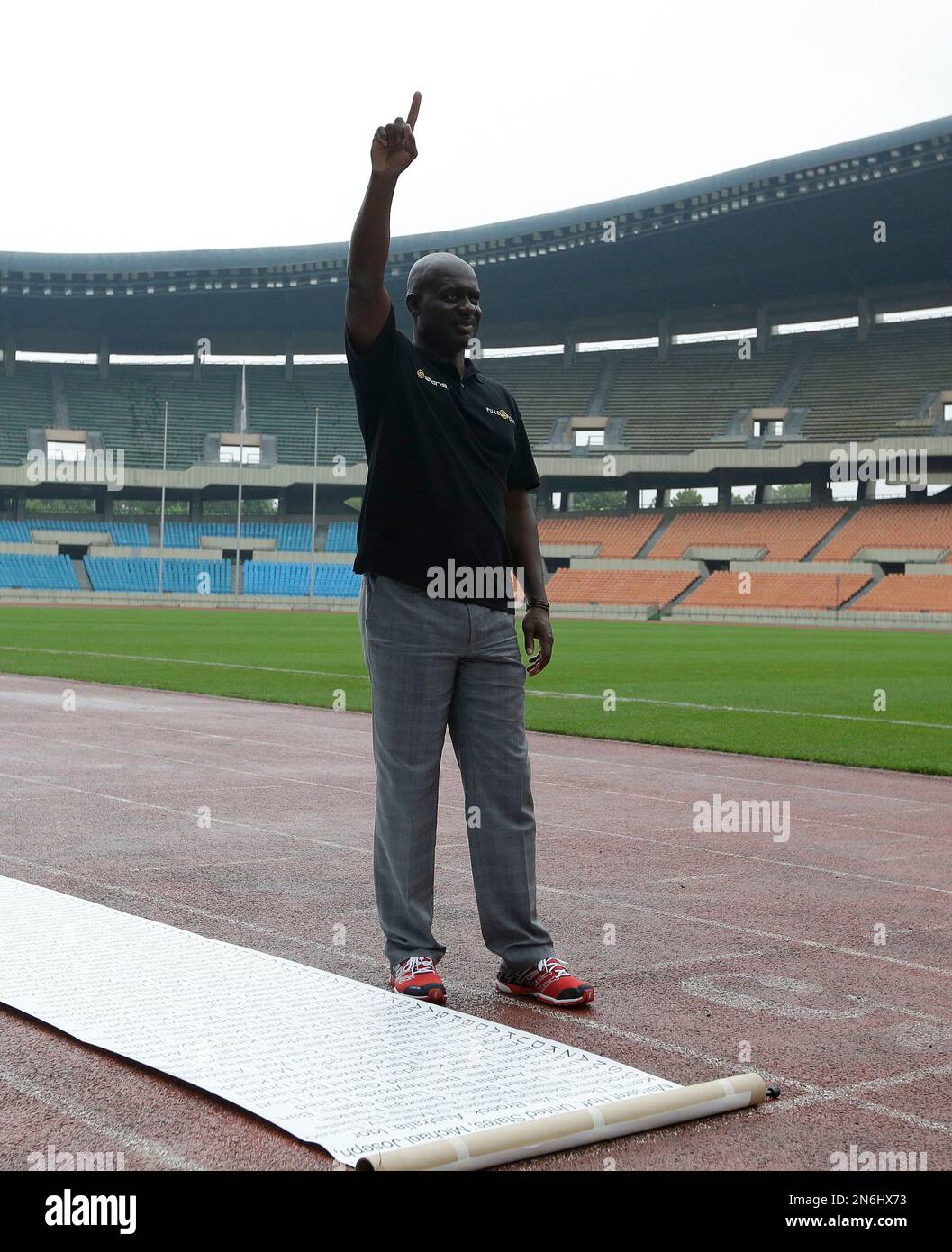 Canada's former sprinter Ben Johnson poses for the media next to a 100 ...