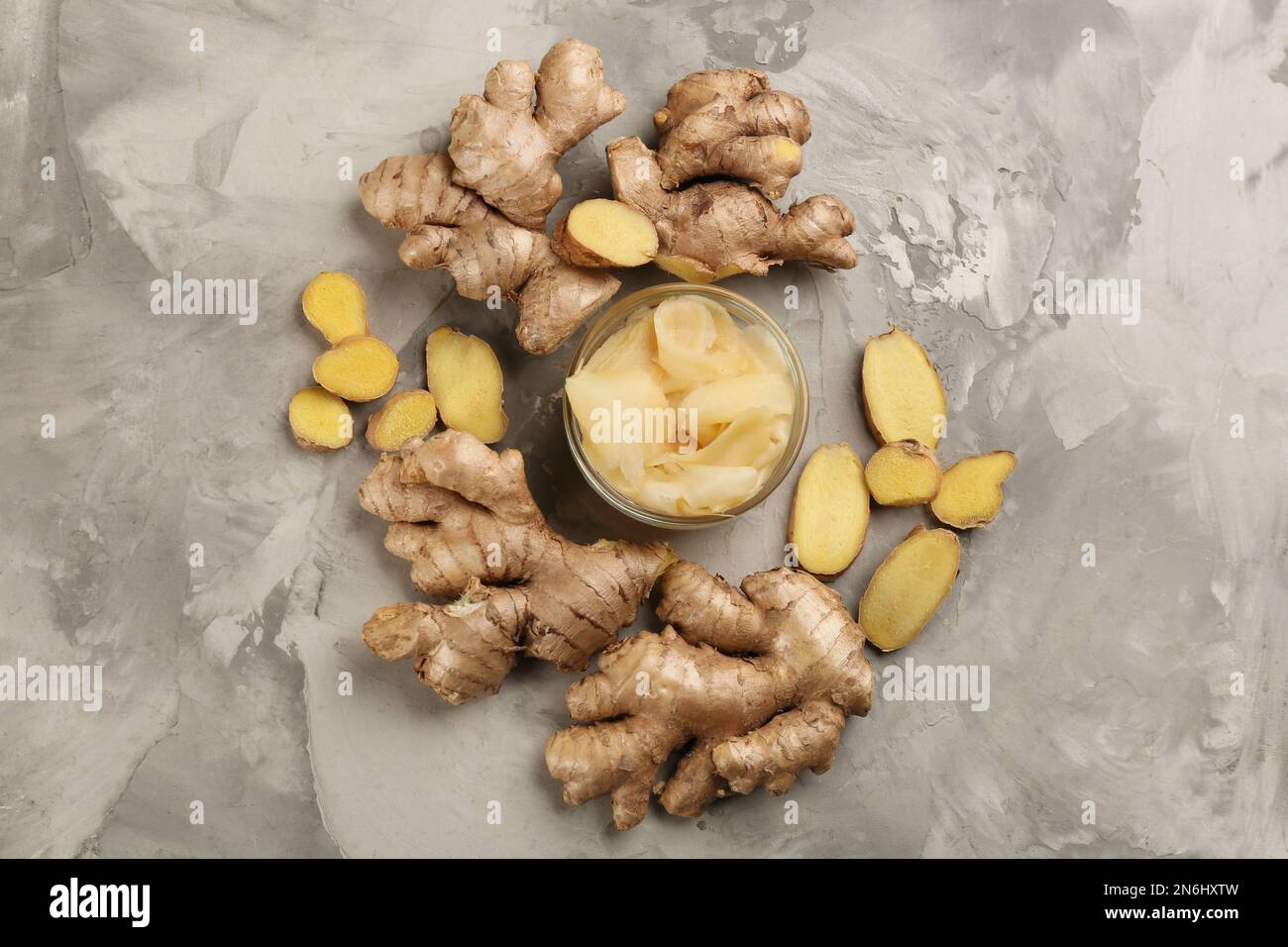 Spicy pickled ginger and root on light grey table, flat lay Stock Photo ...
