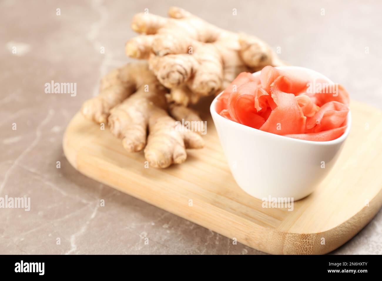 Spicy pickled ginger and root on grey table. Space for text Stock Photo - Alamy