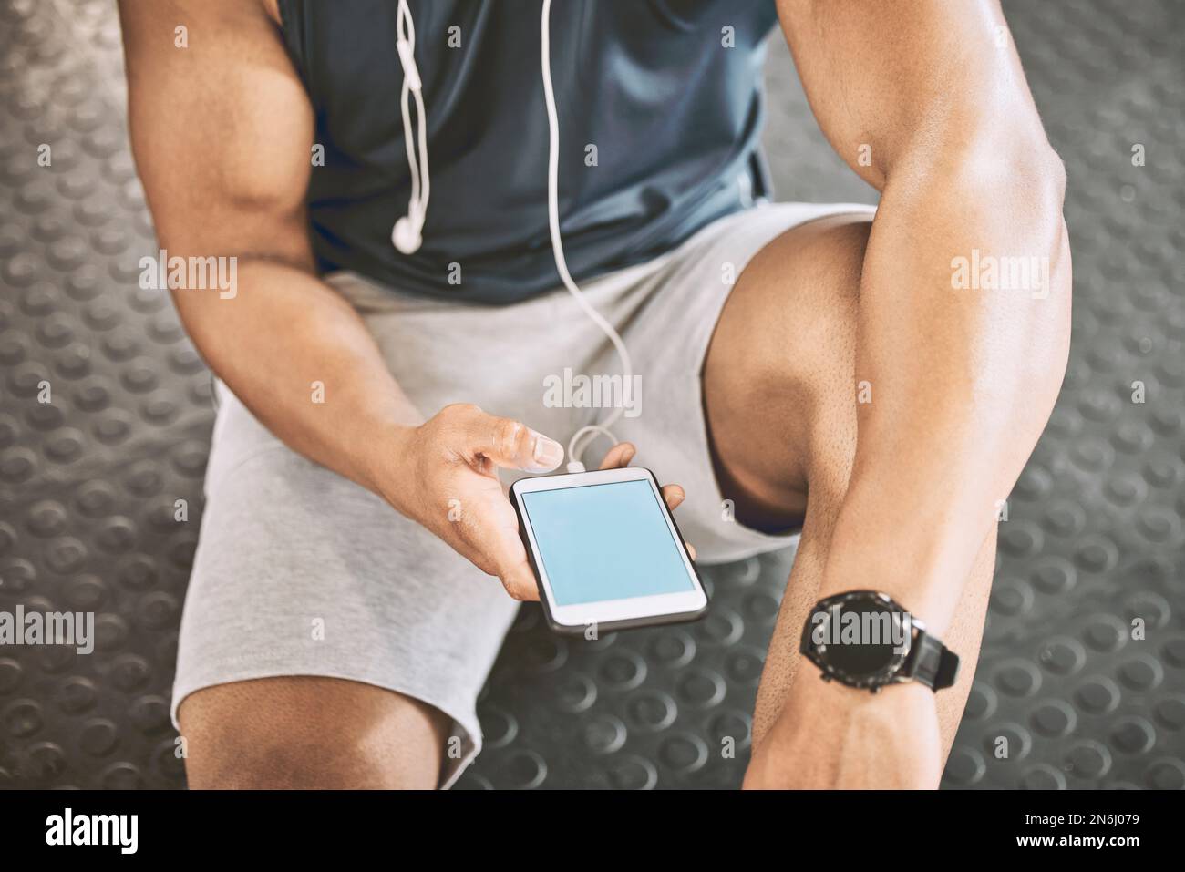 Phone screen of an athlete sending a text in the gym. Fit trainer ...