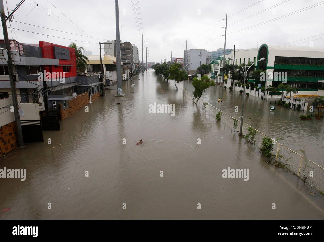 A boy swims in a flooded street at suburban Quezon city, northeast of ...