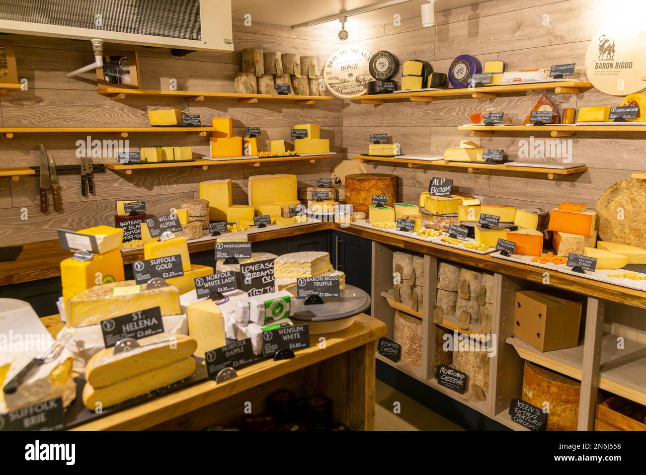 Variety of cheeses on display in cheese room of farm shop, Suffolk ...
