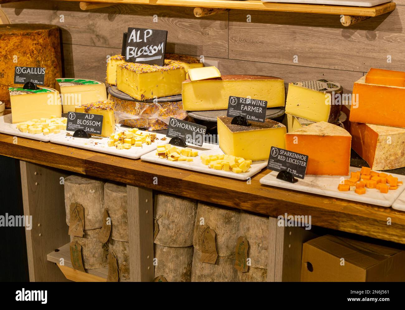 Variety of cheeses on display in cheese room of farm shop, Suffolk ...