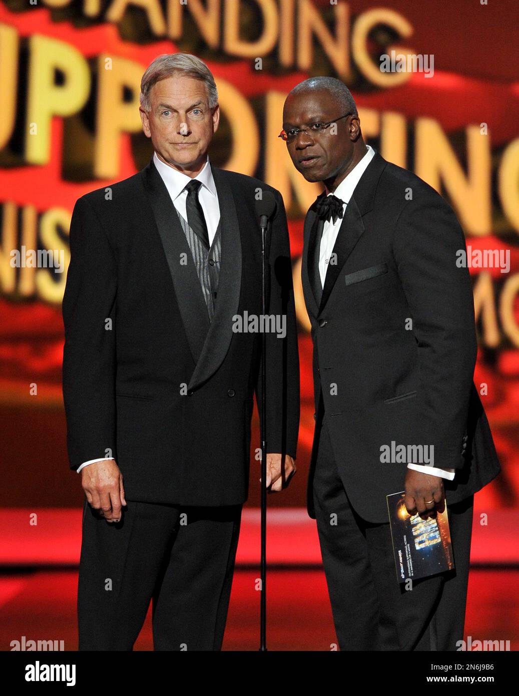 From left, Mark Harmon and Andre Braugher present the award for ...