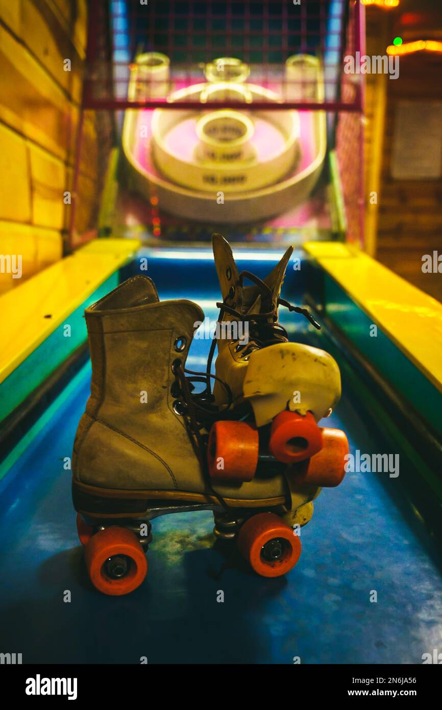 A vertical shot of a pair of old and dirty roller skates at a skating ...