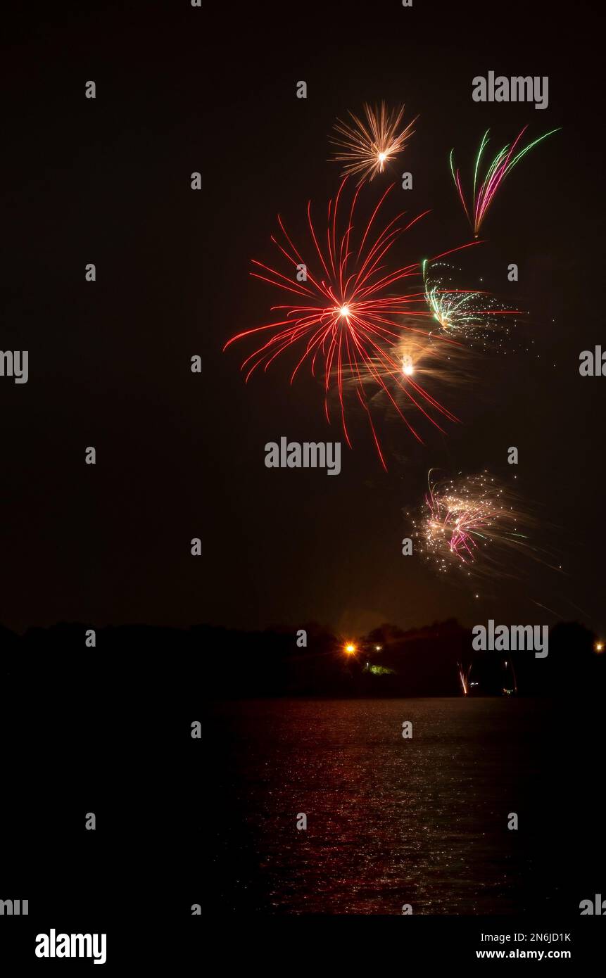 A beautiful colorful firework over sea at night, dark sky background ...
