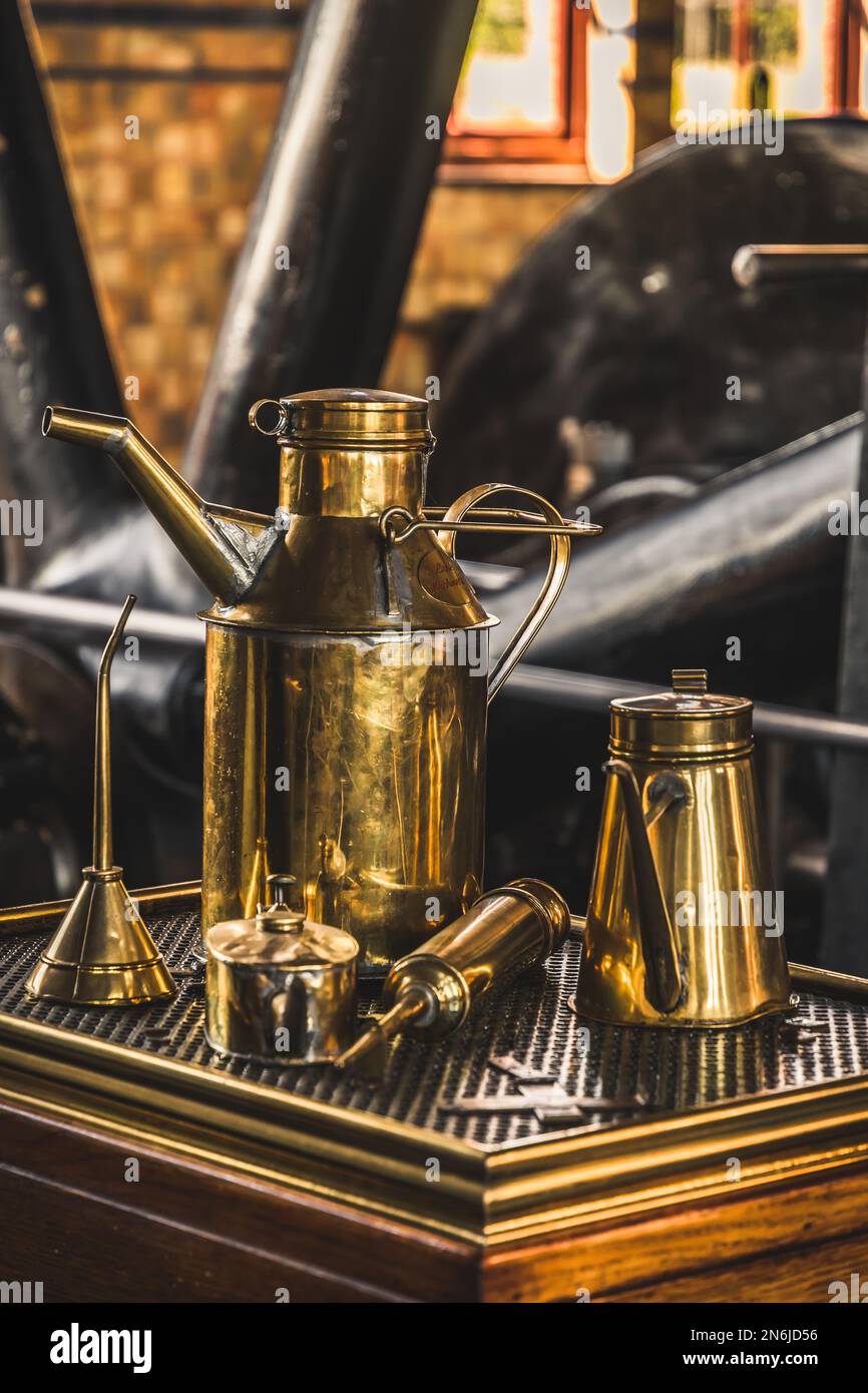 Old brass oil cans for lubricating machines. Turbine of a steam engine ...