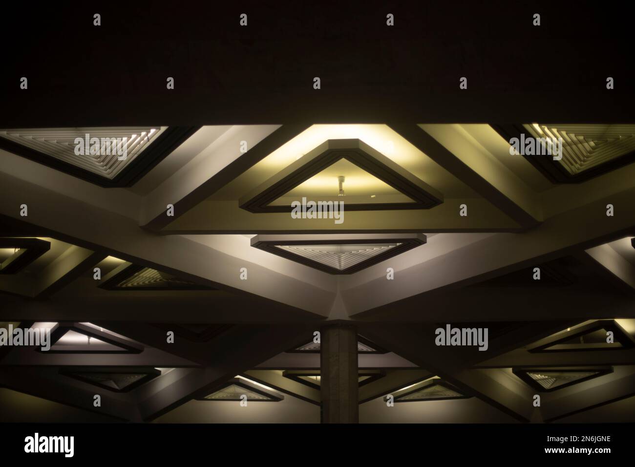 Light of lamps on ceiling. Architecture details. Triangles in building ...