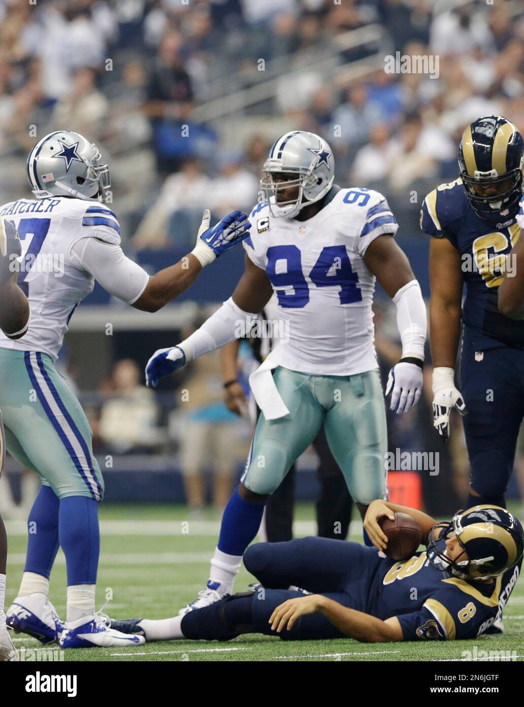 After sacking St. Louis Rams quarterback Sam Bradford (8), Dallas ...