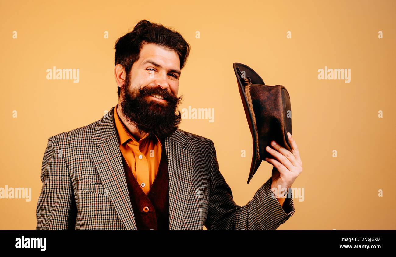 Cheerful smiling gentleman takes off hat in salutation isolated at ...