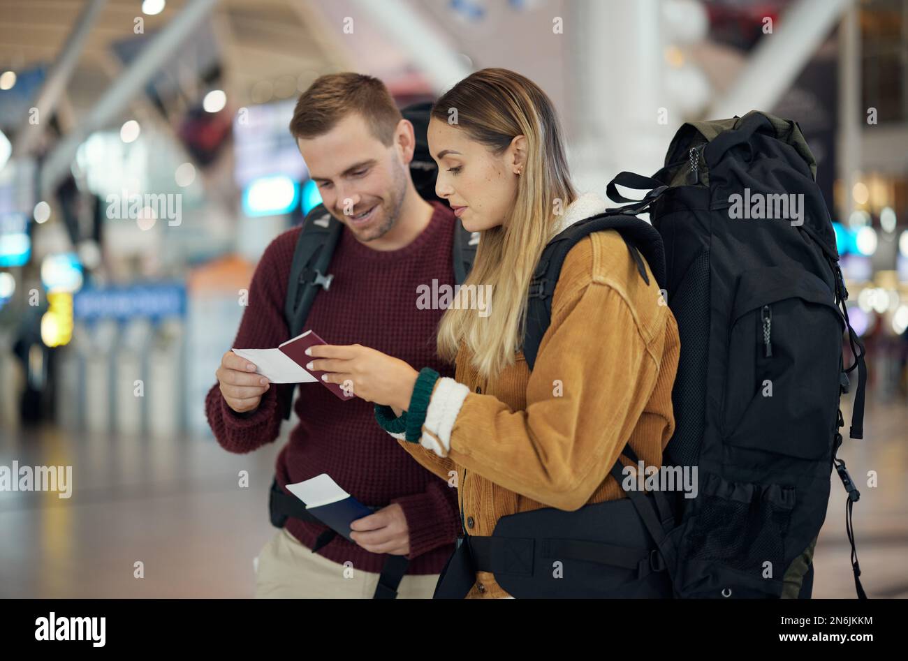 Couple, airport and checking passport for travel, backpacking or ...