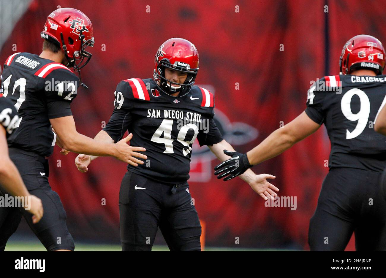 San Diego State kicker Wes Feer, center, is congratulationed by holder ...