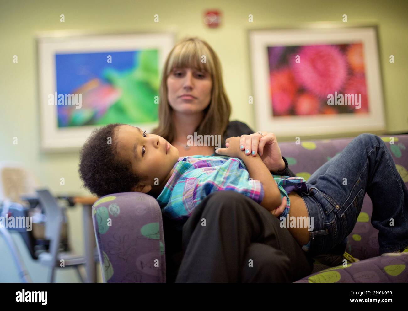 Clinical specialist Catey Funaiock sits with 5-year-old Brandon Dreher ...